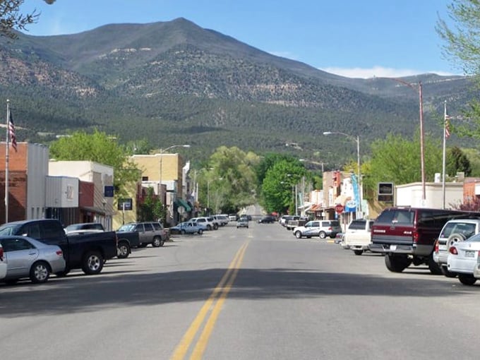 Main Street stretches toward the mountains like an invitation, the buildings standing shoulder to shoulder as if posing for a small-town family portrait.