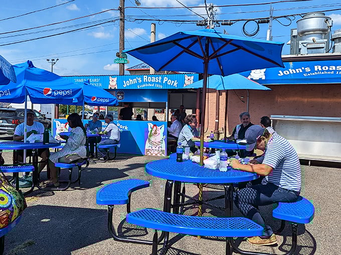 The outdoor dining experience—where blue tables under blue skies create the perfect backdrop for the serious business of sandwich enjoyment.