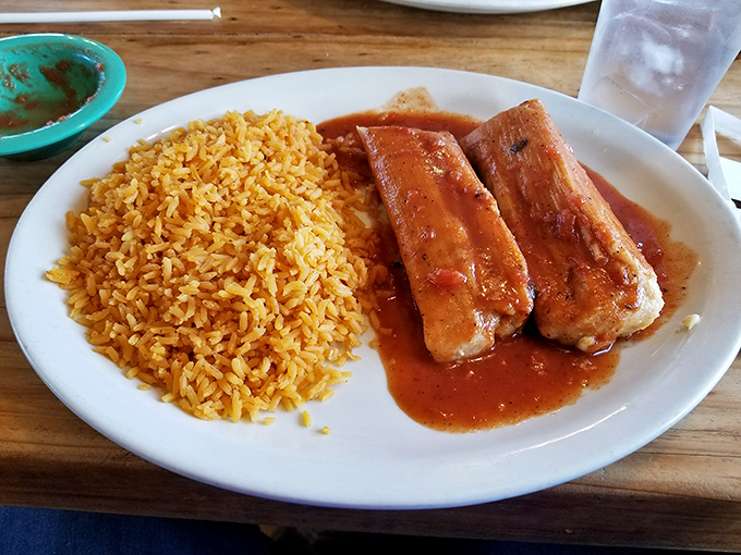 Tamales aren't just food—they're time capsules of tradition. These corn husk-wrapped treasures sit beside rice that's never an afterthought.