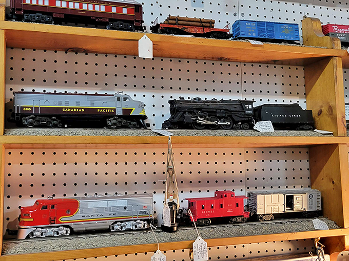 Model trains that once circled Christmas trees now wait patiently for their next conductor. That Canadian Pacific engine probably has more miles in imagination than in actual track.