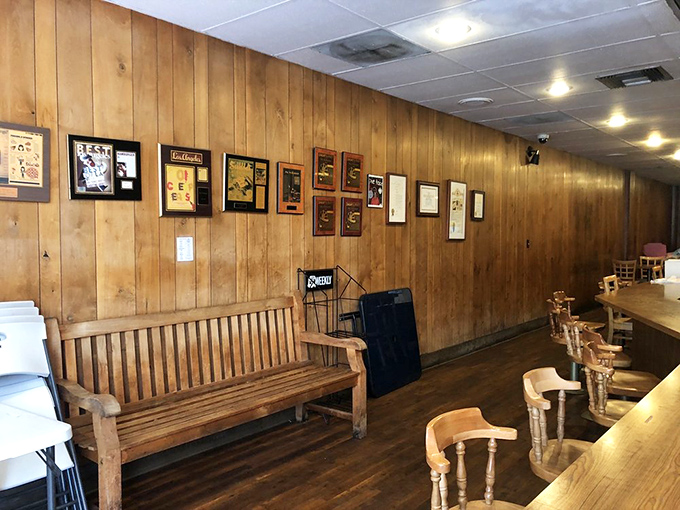 The waiting area's wooden bench and wall of fame suggest you're not just waiting for a table—you're joining a lineage of satisfied diners.