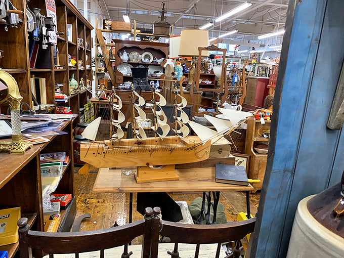 This meticulously crafted model ship sails through time rather than water, anchored among furniture that's weathered real-life journeys of its own.