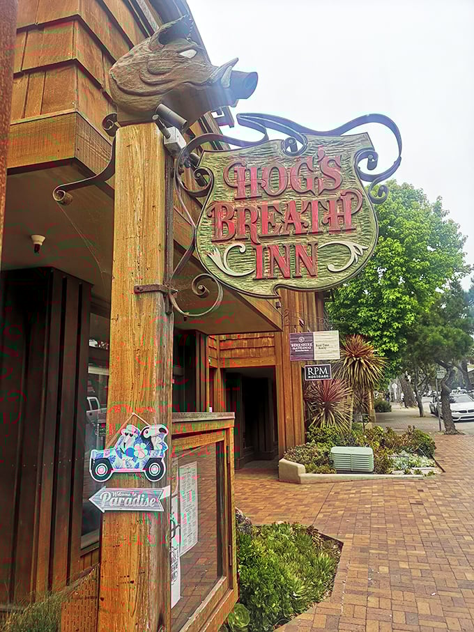 Hog's Breath Inn's whimsical sign featuring a wooden pig – Carmel's storybook charm meets serious steak business.