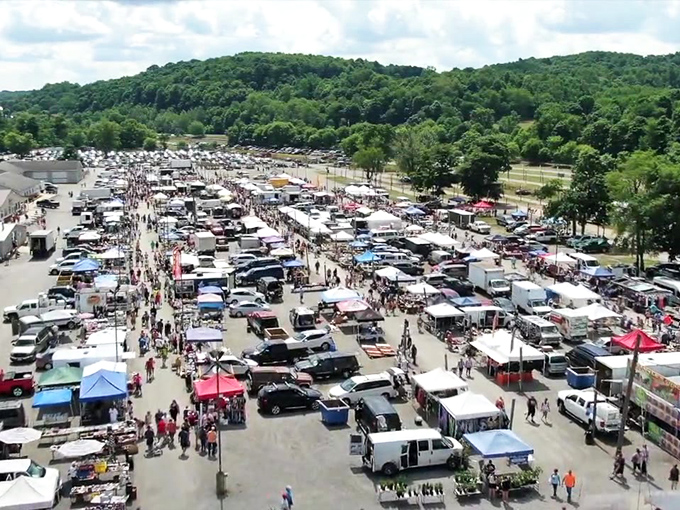 The magnificent scope revealed! This aerial view shows the impressive scale of Rogers Flea Market, where thousands gather for the weekly treasure hunt.