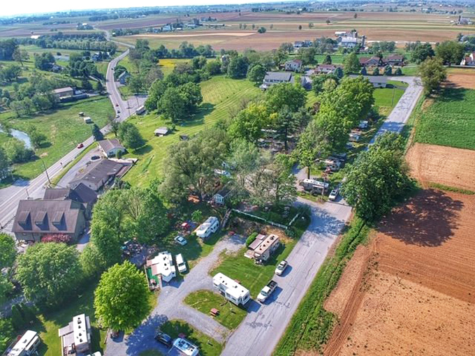 From above, the patchwork of farms, roads, and gatherings reveals the intentional simplicity of a community that chose its own pace.