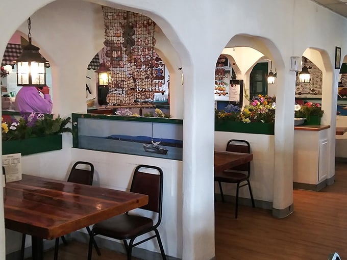 White arches frame cozy dining nooks, creating the feeling you've discovered a Mediterranean seaside café in the heart of Phoenix.