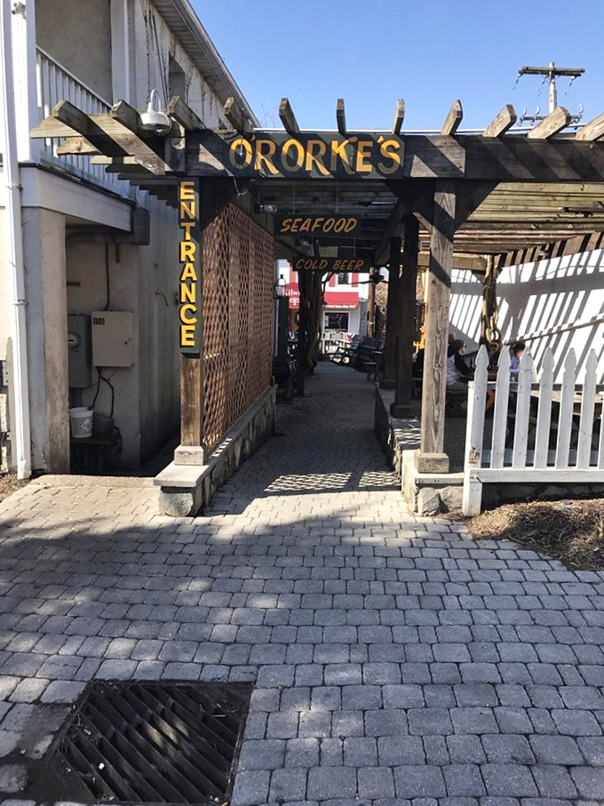 The back entrance promises seafood and cold beer—two magic words that have lured countless hungry souls through this archway.
