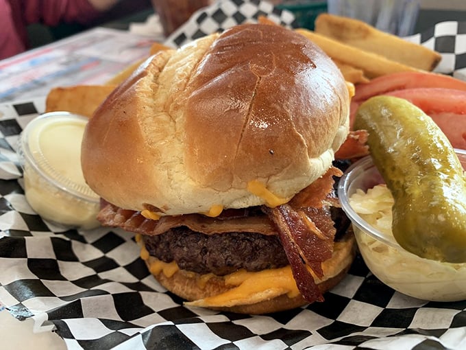 A burger that requires both hands, a stack of napkins, and a moment of silent appreciation before the first magnificent bite.