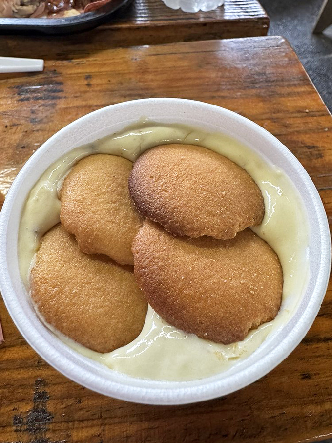 Banana pudding that doesn't just end the meal, it punctuates it – those vanilla wafers floating like edible life rafts in a sea of creamy bliss.