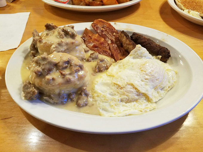 Biscuits and gravy with sunny-side up eggs isn't breakfast – it's an edible monument to mornings done right and a shield against whatever the day holds.
