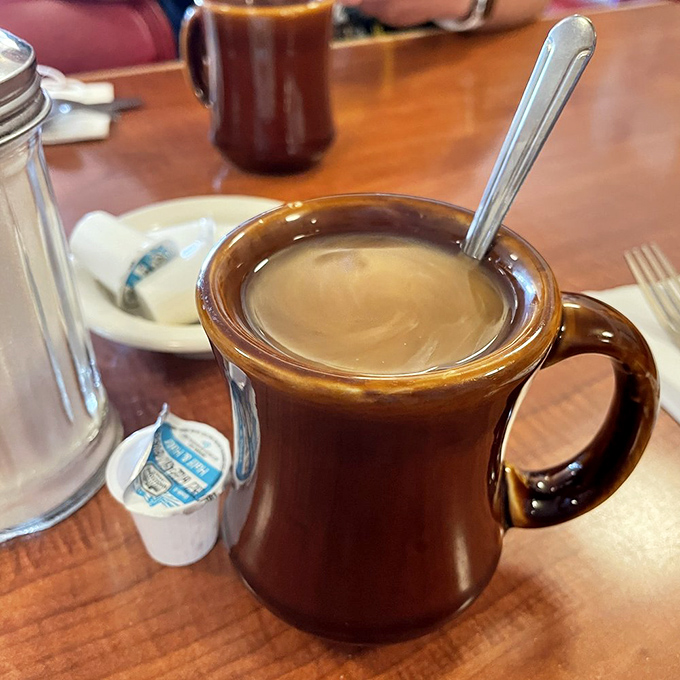 The humble brown coffee mug—keeper of secrets, starter of days, and proof that sometimes the simplest pleasures are the most reliable.