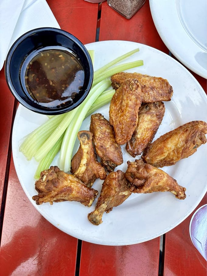 These wings aren't playing second fiddle to burgers—they're conducting their own spicy symphony with crispy skin and tender meat that falls off the bone.