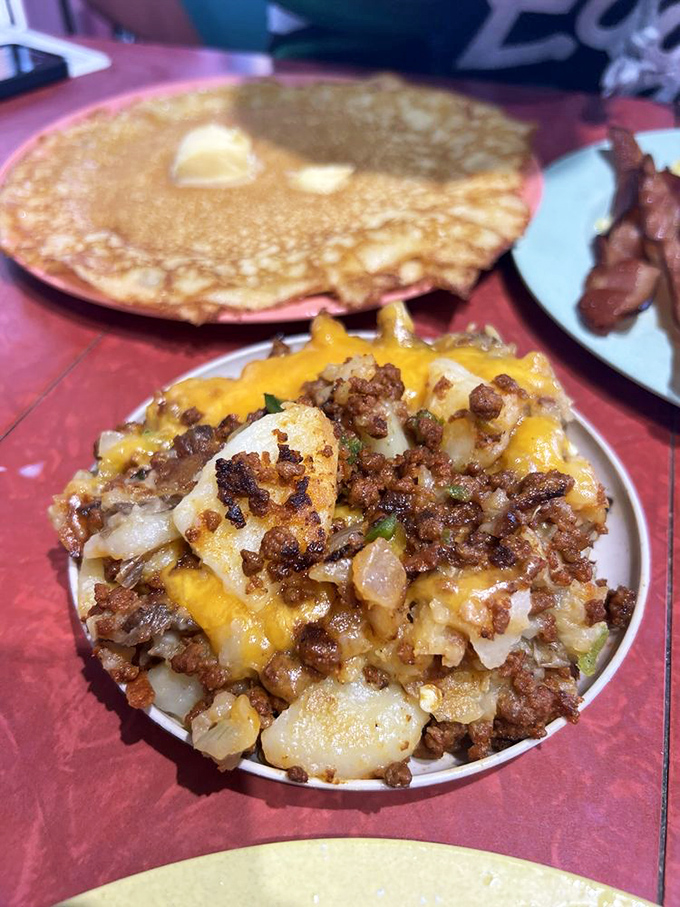 The chorizo hash doesn't just sit on the plate—it commands attention with melted cheese crowning a throne of spicy sausage and potatoes.