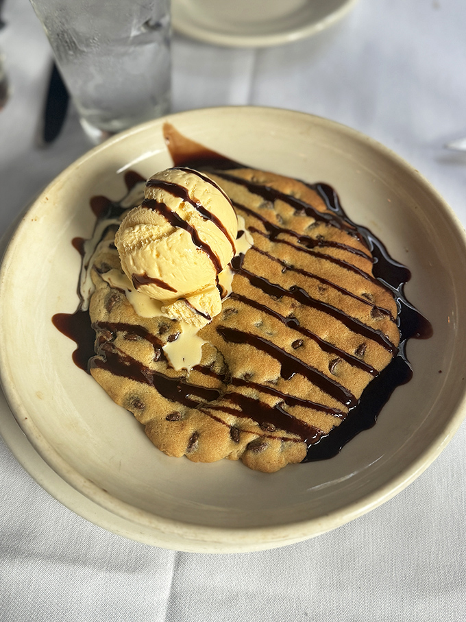 A warm cookie crowned with ice cream that proves the best relationships are built on contrasts—hot and cold, crisp and creamy, gone too soon.