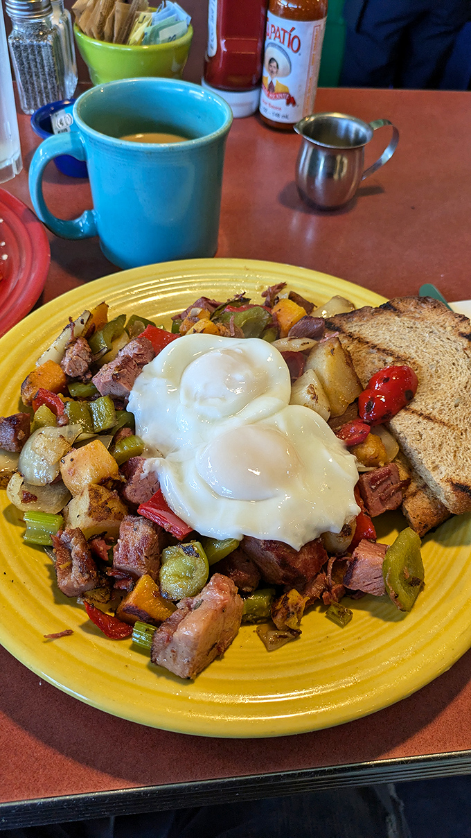A colorful hash that's like a treasure hunt on a plate – each bite offering a new combination of flavors beneath those perfect eggs.