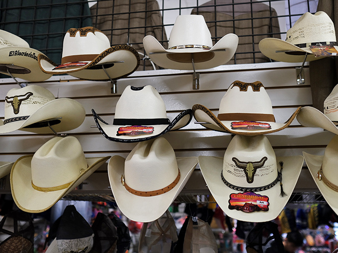 The cowboy hat wall offers headwear that ranges from "first rodeo" to "been running cattle since before you were born"—instant character for any head.