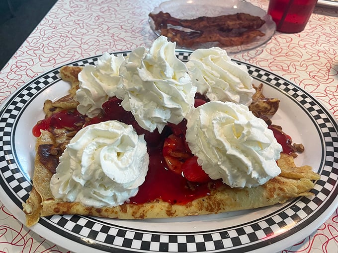 Not just dessert, but edible art: crepes adorned with fruit, sauce, and whipped cream mountains that dare you not to smile.