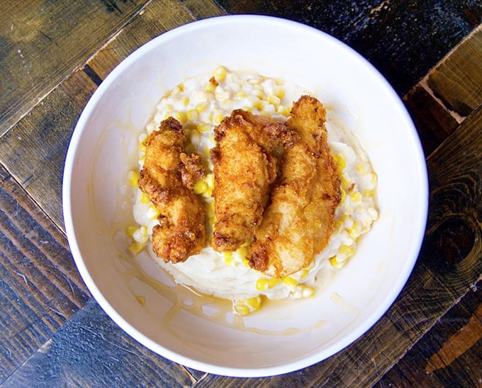Crispy chicken nestled on a cloud of mashed potatoes – comfort food that bridges cultures and reminds us why simple pleasures often taste the best.