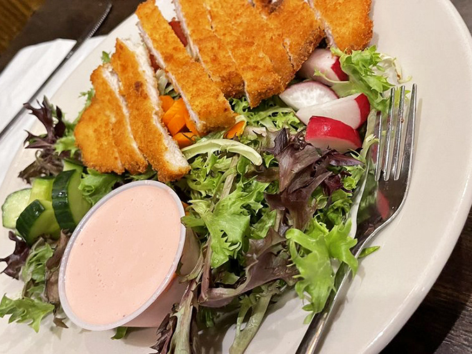 A crispy chicken salad that proves Germans understand more than just meat and potatoes – those golden cutlet pieces practically demand a fork salute!