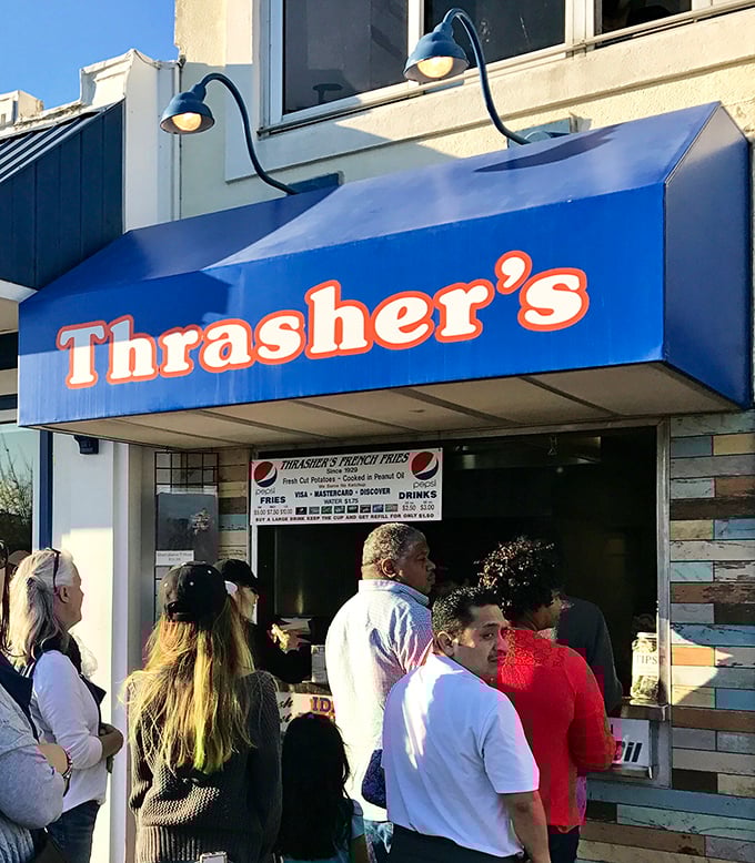 The universal language of anticipation. These patient pilgrims know that greatness can't be rushed—especially when it involves peanut oil.