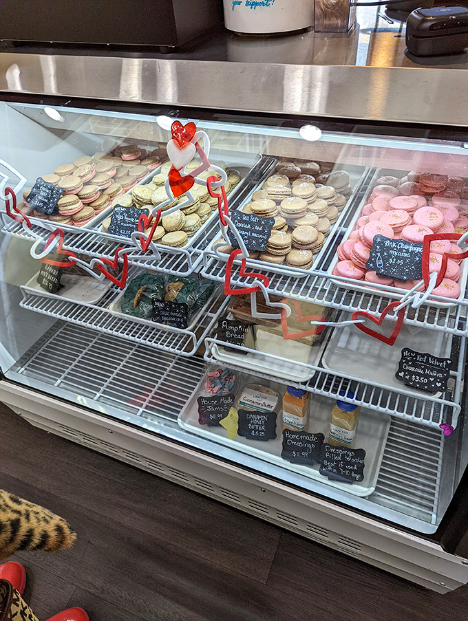 The dessert case—where macarons and sweet treats wait patiently, knowing you'll eventually abandon all willpower after your magnificent meal.