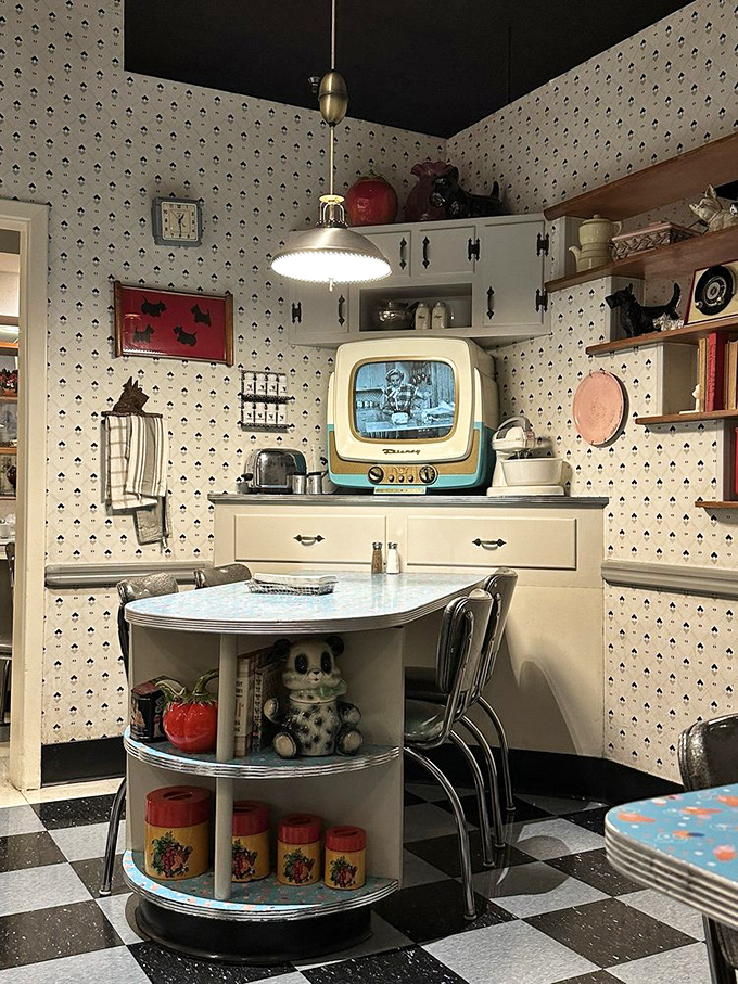 That vintage TV isn't just decoration—it's playing actual 1950s shows, completing the immersive experience of dining in another era.