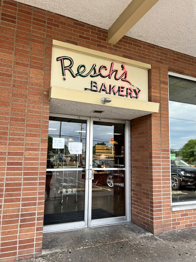 The entrance to carbohydrate paradise, where the neon sign serves as both beacon and warning: resistance is futile.