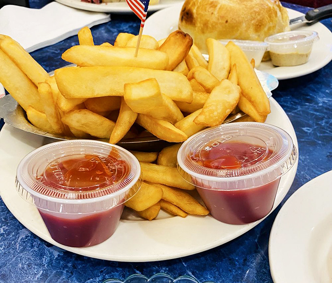 Golden, crispy french fries with not one but two cups of ketchup—because when you're serving portions this size, condiment conservation is not a concern.
