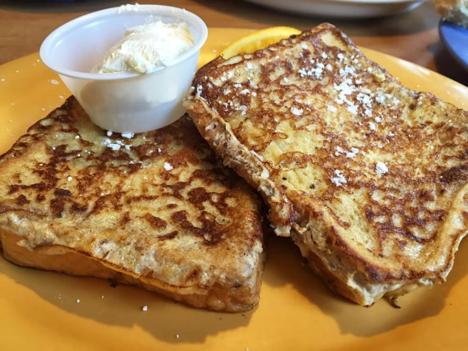 Golden-brown French toast that's crispy outside, custardy inside, with a dollop of whipped butter slowly melting into those perfect squares of deliciousness.