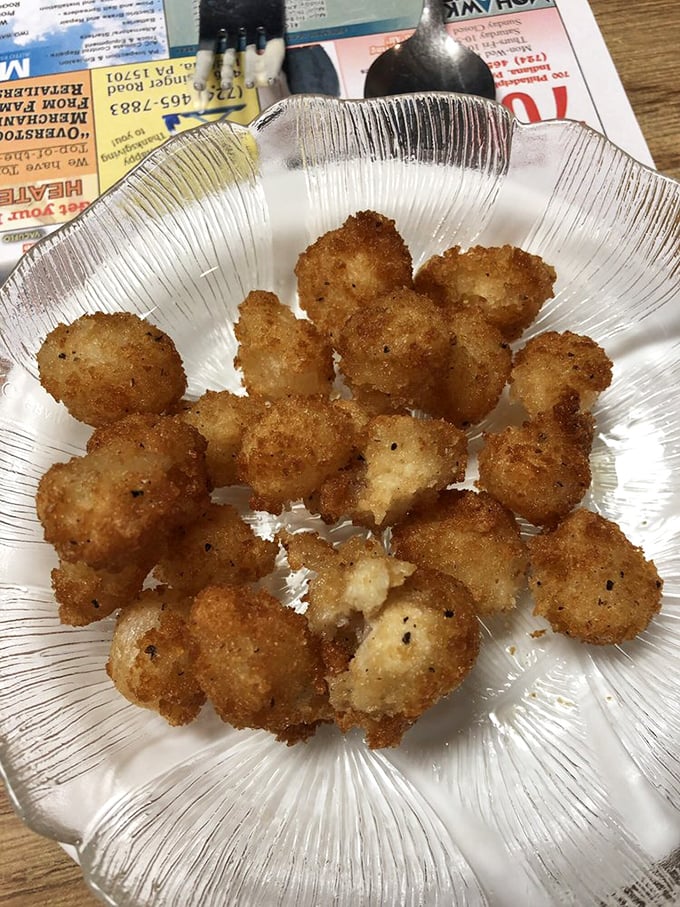 These golden-fried cocktail onions aren't just an appetizer—they're little crispy orbs of joy that disappear faster than you can say "I'll just have one more."