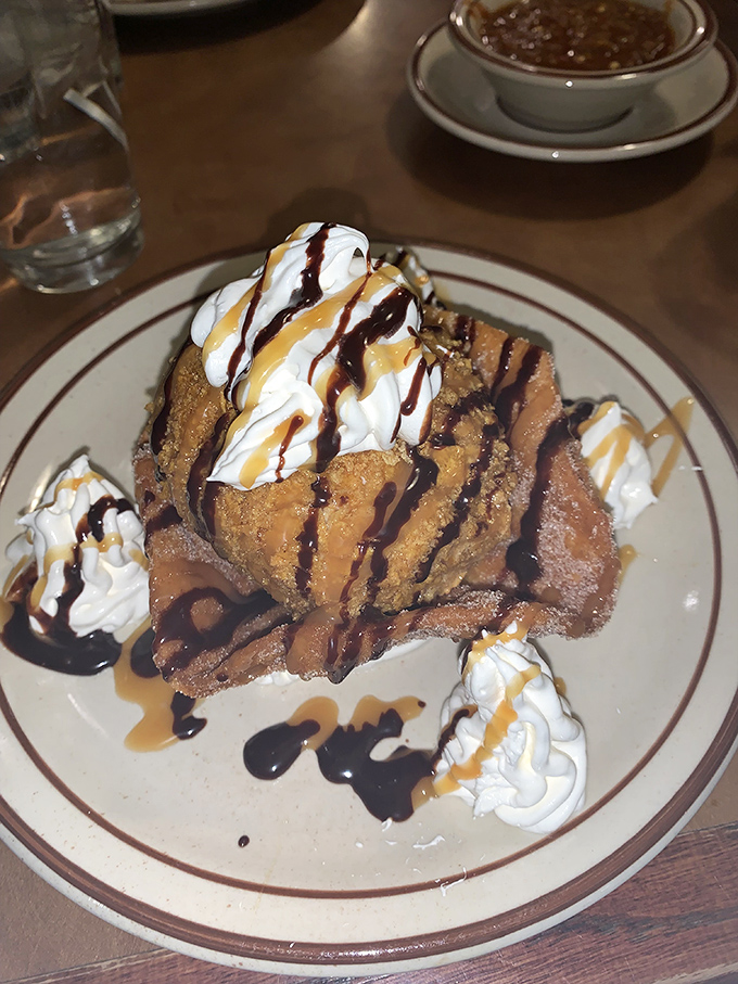 This isn't just fried ice cream—it's a sweet, crunchy contradiction wrapped in whipped cream and drizzled with pure joy.