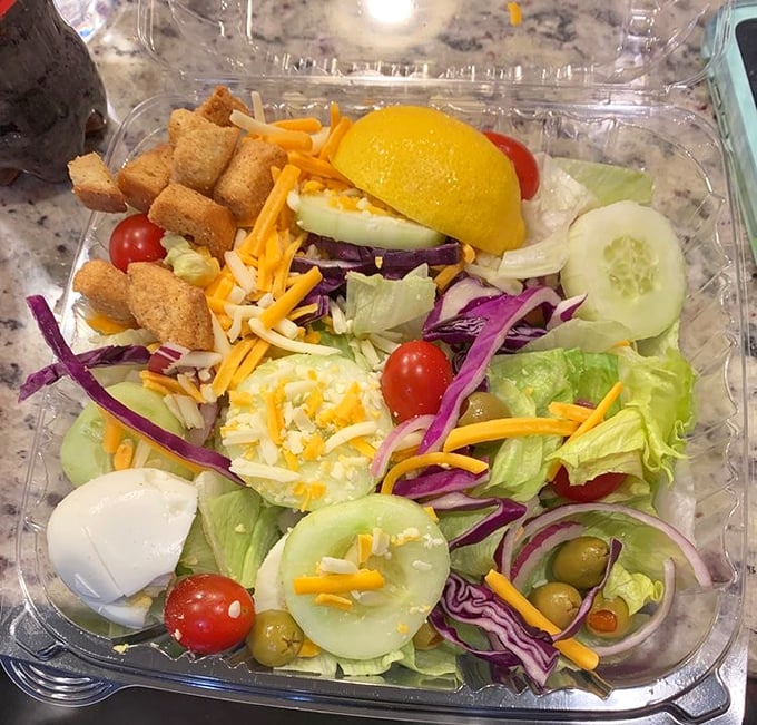 Even the salad looks happy to be here—fresh, colorful, and proving that occasionally eating something green makes all that fried chicken justified.