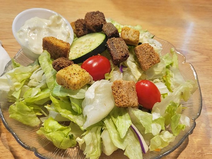 A garden salad that proves vegetables have a rightful place at a steakhouse—crisp, colorful, and crowned with house-made croutons.