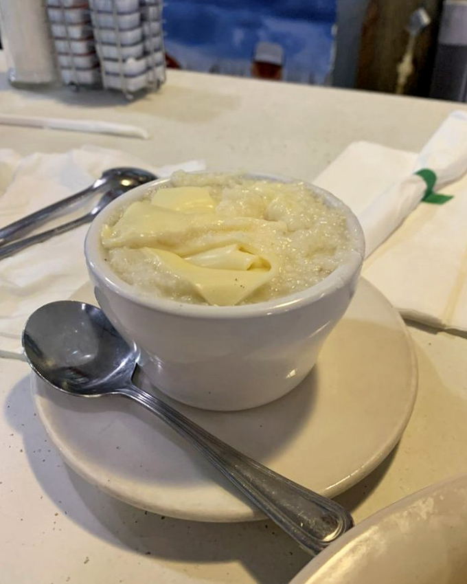 Grits with melting butter that would make any Southerner nod in approval. Simple perfection in a small white bowl—comfort food's ambassador to the breakfast table.