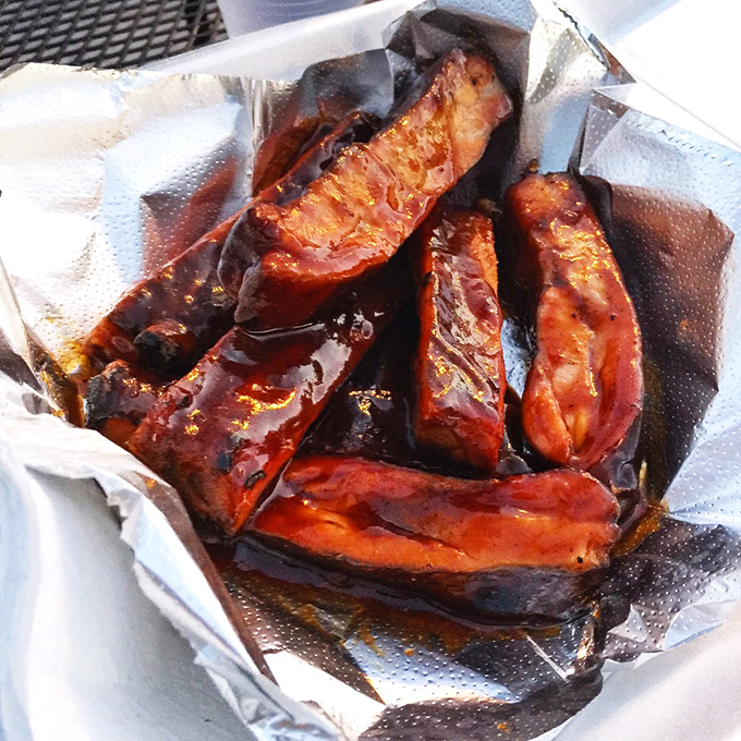 Ribs glistening with sauce like they've just stepped out of a barbecue fashion shoot—these aren't just cooked; they're pampered.