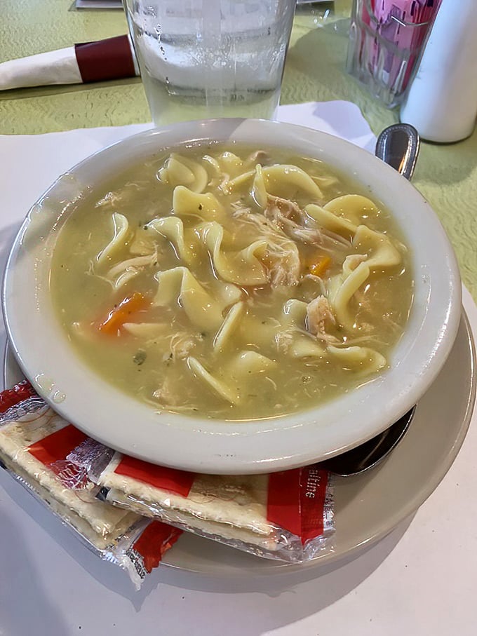 Chicken soup with noodles wide enough to use as tiny rafts—the penicillin your grandmother prescribed that actually works.