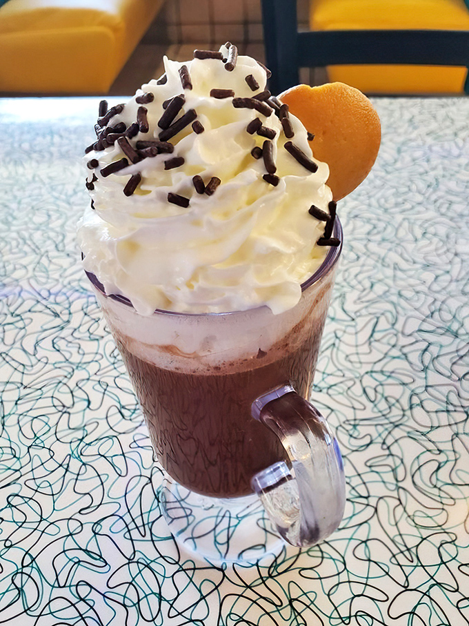 Hot chocolate that doesn't just arrive—it makes an entrance. Those whipped cream mountains with chocolate sprinkles are what childhood dreams are made of.