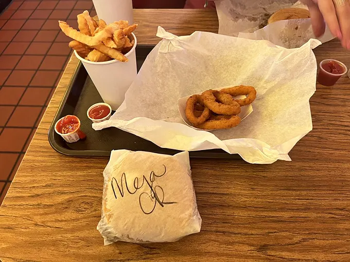 The ultimate Maid-Rite spread – where onion rings, fries, and a wrapped sandwich create a still life more beautiful than any Renaissance painting.