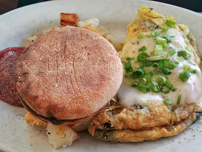 This isn't just an omelet—it's an architectural achievement with layers of egg, cheese, and green onions that deserves its own blueprint.