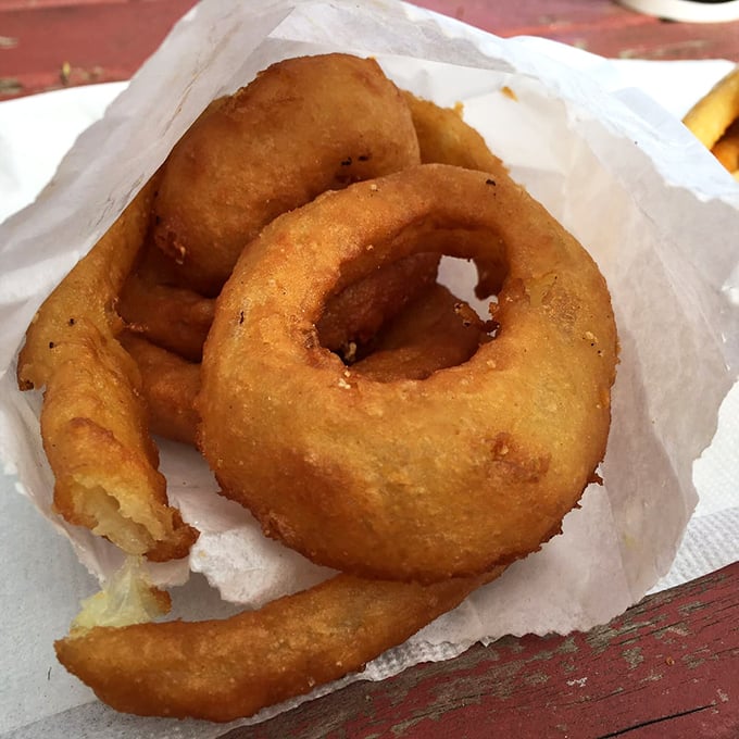 Onion rings that achieve that perfect balance—substantial enough to satisfy, with a light batter that shatters just right with each bite.