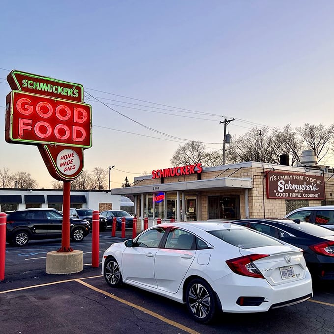 As the sun sets, Schmucker's neon sign glows like a beacon of hope for those seeking refuge from a world of pretentious food trends.