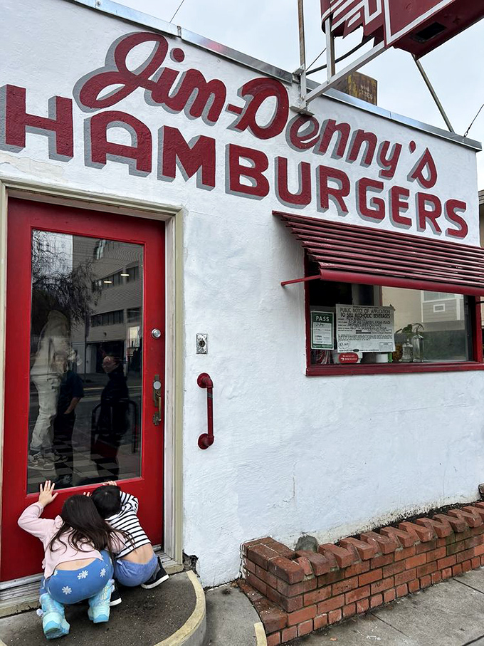 Even the kids know where the good stuff is—peeking through the door of this white-and-red temple of comfort food classics.