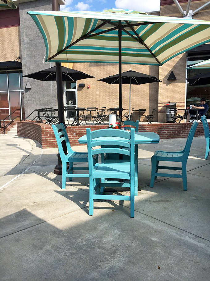 Turquoise chairs under striped umbrellas—the perfect spot to savor those last bites while plotting your inevitable return.