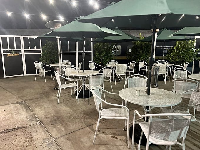 The outdoor seating area transforms into a twinkling oasis after dark—perfect for enjoying those loaded fries under the stars on a balmy Florida evening.
