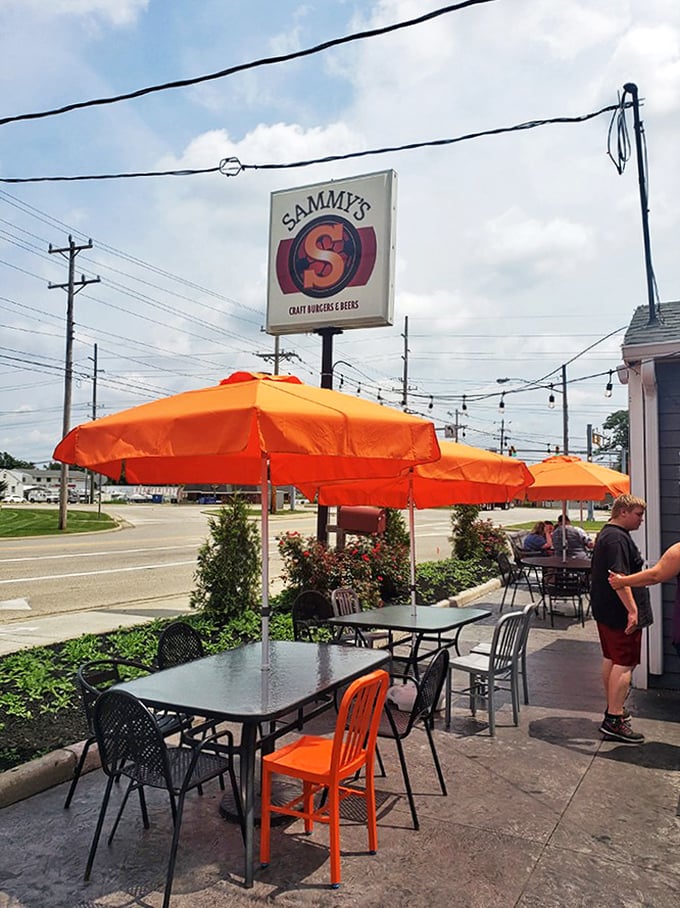 Bright orange umbrellas signal to passing cars: "Yes, outdoor seating is available, and yes, you should absolutely stop what you're doing and eat here."