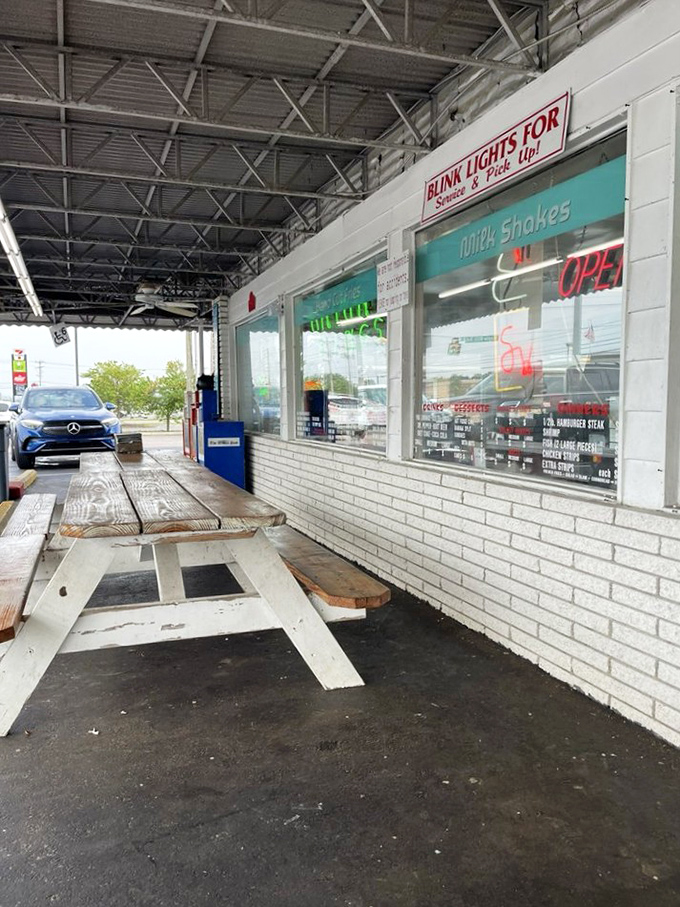 Those picnic tables outside aren't just seating—they're front-row tickets to a small-town Tennessee summer day, with burgers as the headliner.