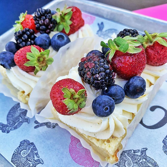 A cloud of cream crowned with nature's jewels—berries that pop against the white canvas like an edible Impressionist painting.