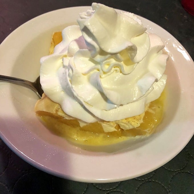 The peach kuchen topped with whipped cream isn't just dessert—it's the sweet finale to a meal that feels like coming home.