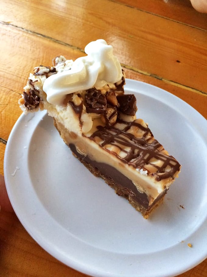 This isn't just dessert—it's a peanut butter pie that makes you question why chocolate gets all the attention, topped with a dollop of whipped cream that's basically wearing a halo.