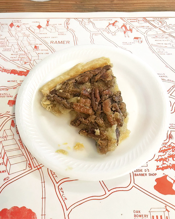 This isn't just pecan pie—it's Alabama's soul on a plate, served atop a map that reminds you exactly where this sweet, nutty perfection was born.